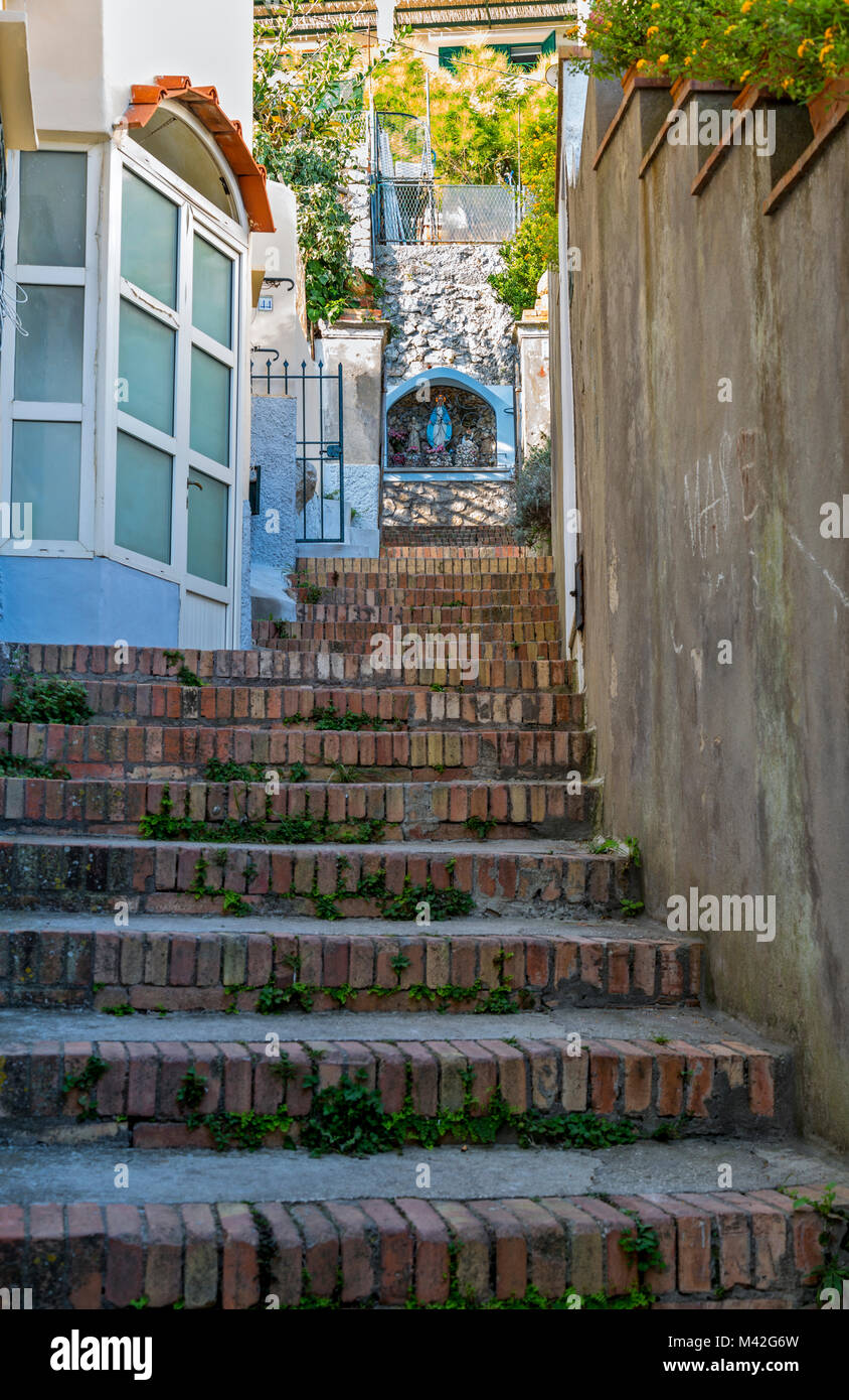 Steep stairs leading to an outdoor shrine to the Virgin Mary in a stone ...