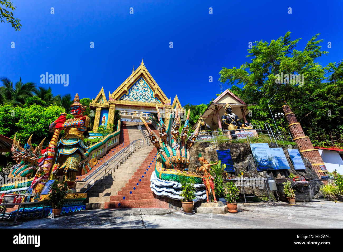 The main stairs leading to Wat Khao Rang temple with boards description ...