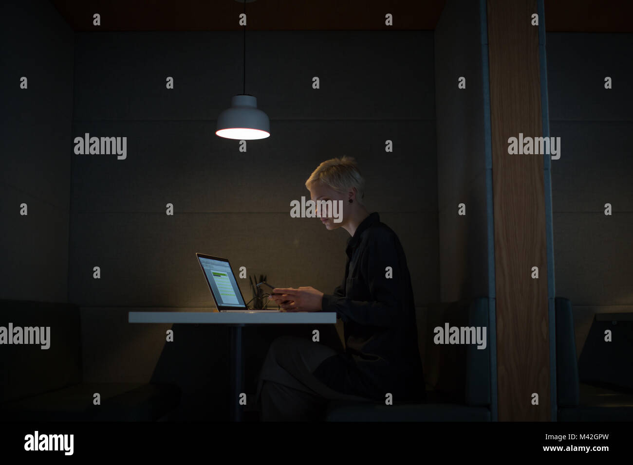 Businesswoman working late at night in office alone Stock Photo - Alamy