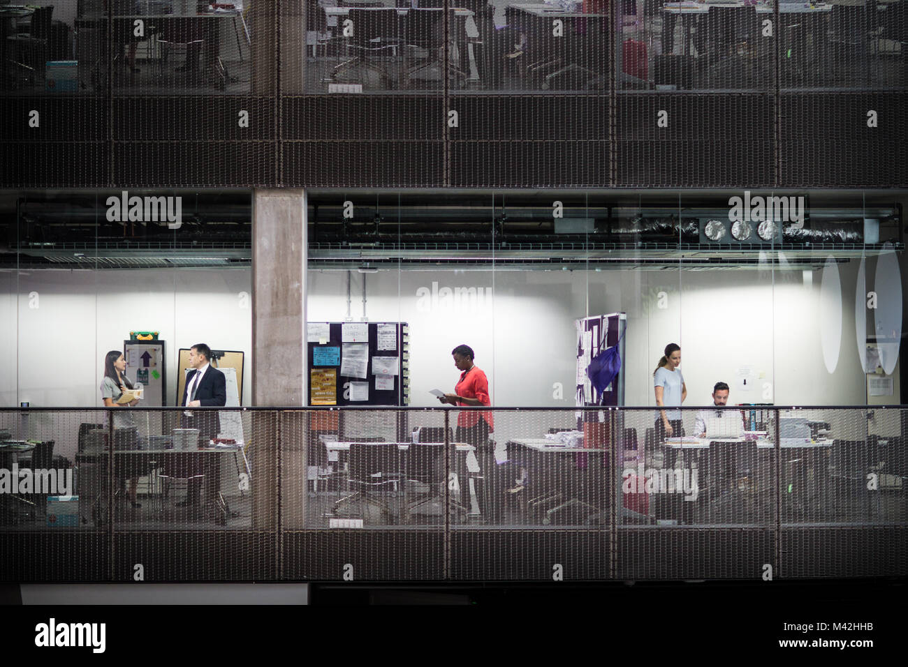 Busy office at night Stock Photo - Alamy