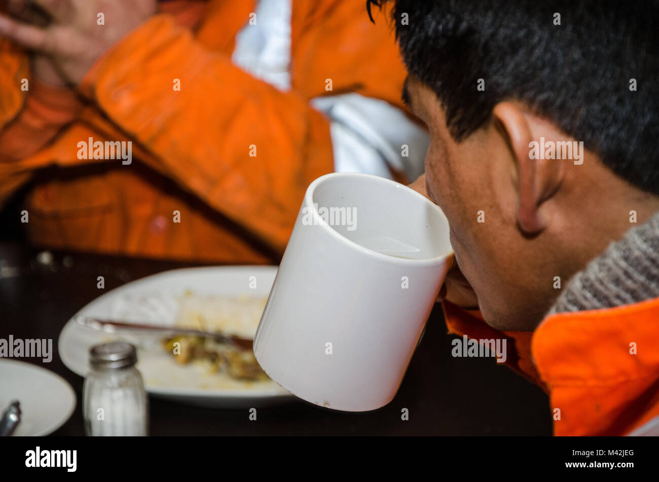 Miner drinking coffee and eating a bread Stock Photo - Alamy