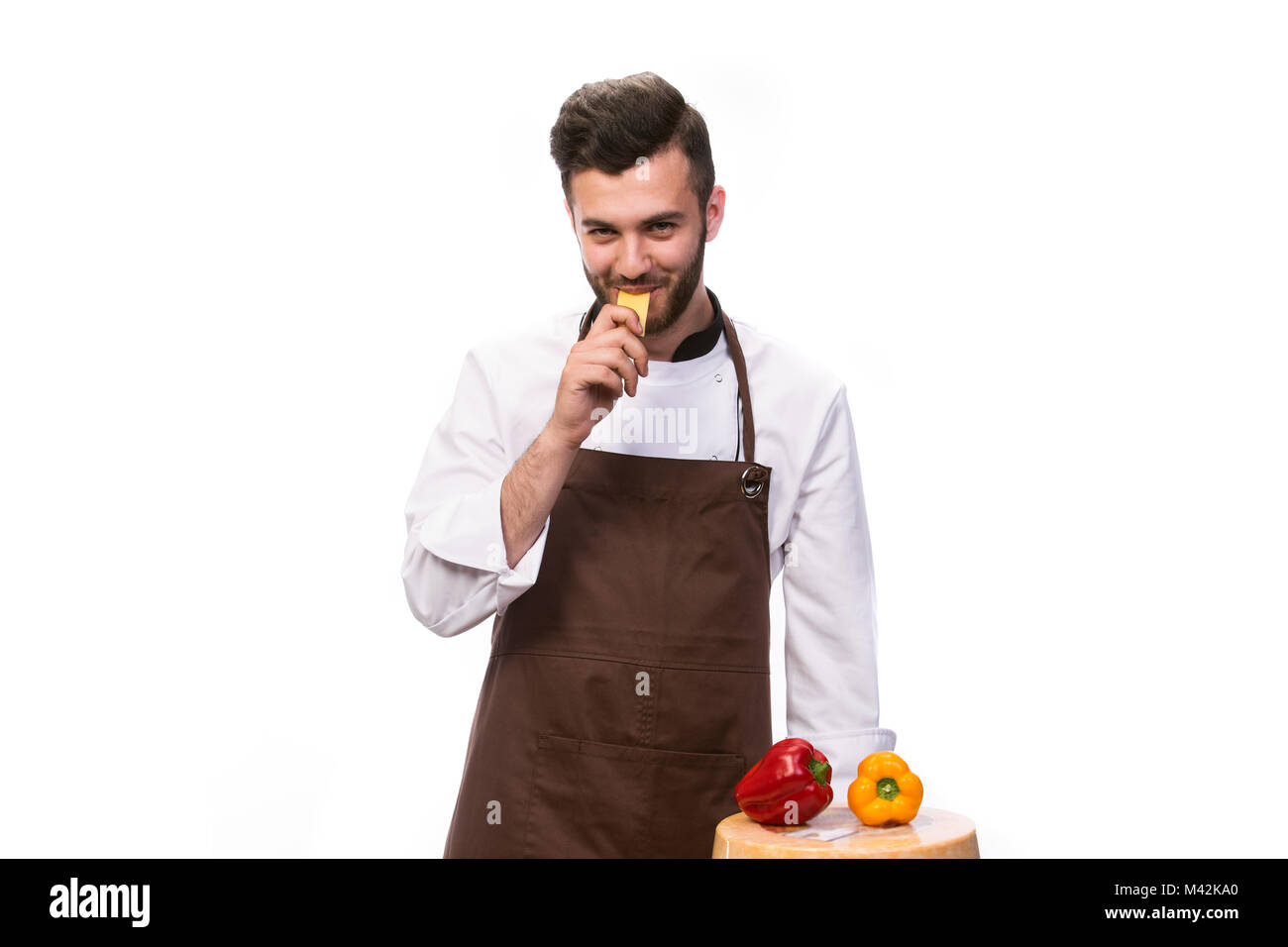 funny chef bites cheese, isolated on white background Stock Photo - Alamy