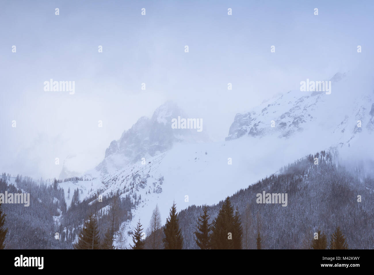 winter mountain peak hidden in mist Stock Photo - Alamy