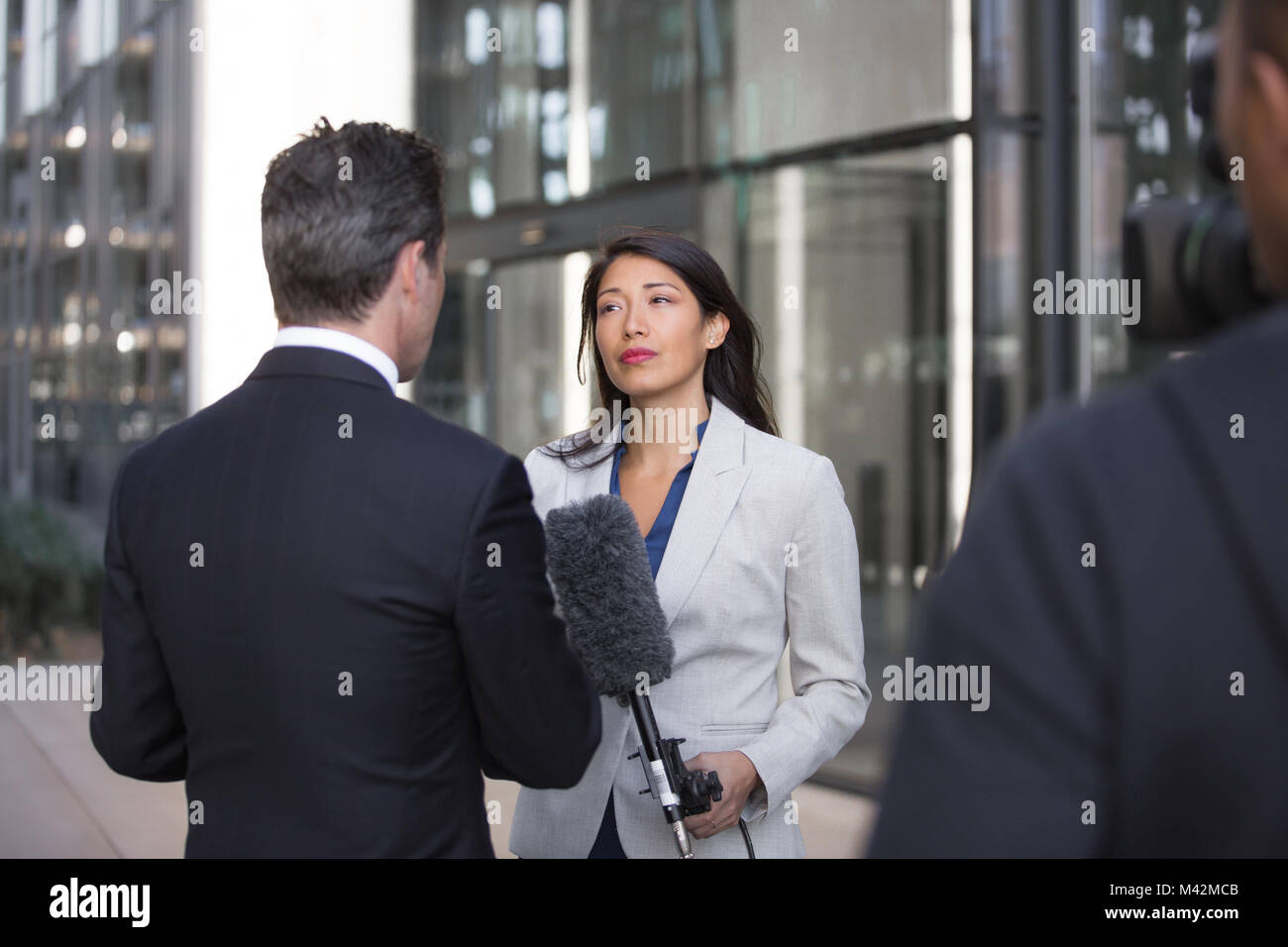 News presenter interviewing on the street Stock Photo - Alamy
