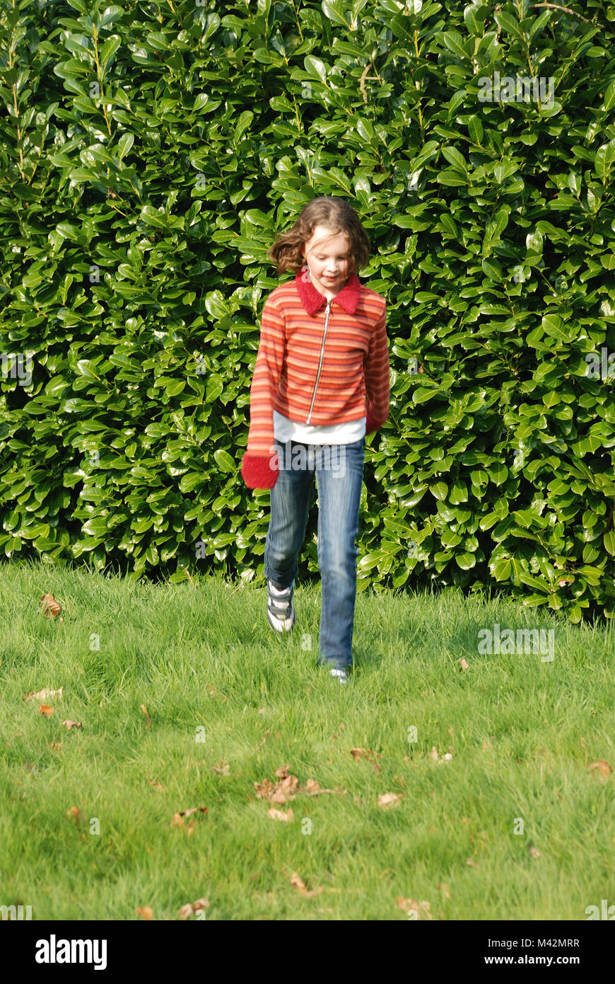 Girl running in the garden Stock Photo - Alamy