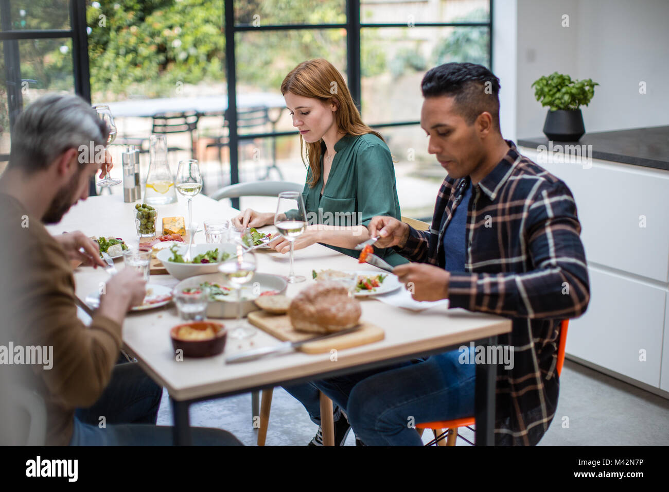 Friends enjoying a meal together Stock Photo - Alamy