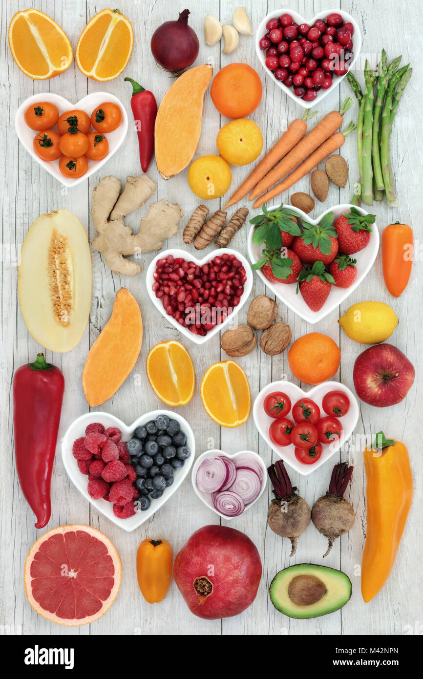 Healthy heart food concept with fruit, vegetables, nuts, herbs and ...