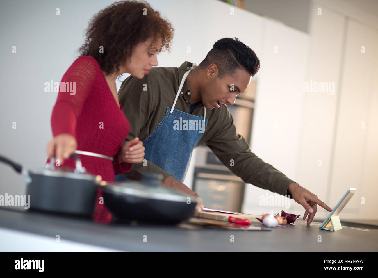Woman cooking using tablet hi-res stock photography and images - Alamy