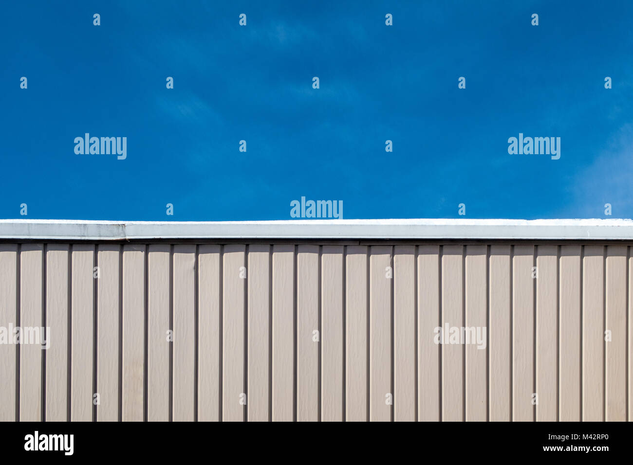 Half wall half blue sky . Top part of the picture is blue sky, bottom ...