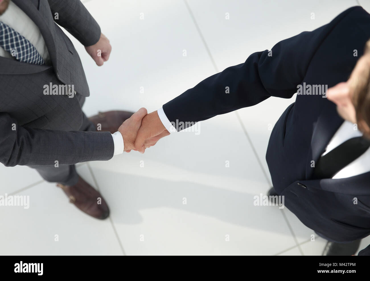 Two business men shaking hands in the office Stock Photo - Alamy