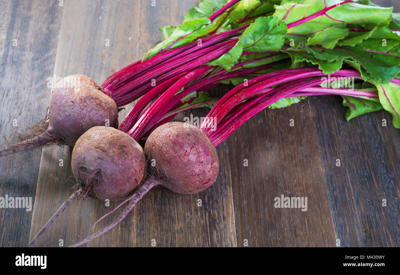 Fresh whole beetroots with leaves on wooden rustic table.Whole ...