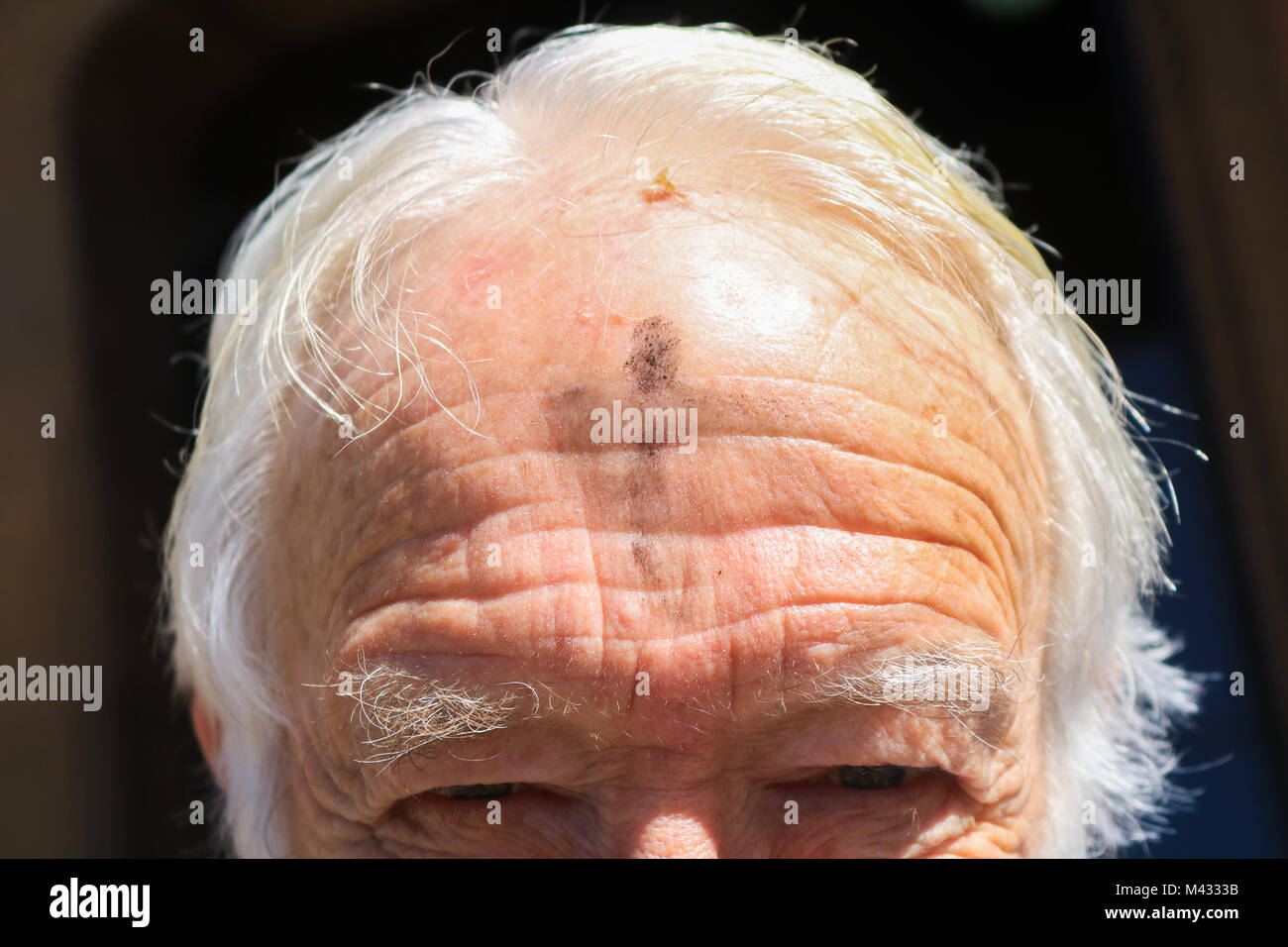 Adelaide, Australia. 14th Feb 2018. A cross of ashes is ceremonially ...