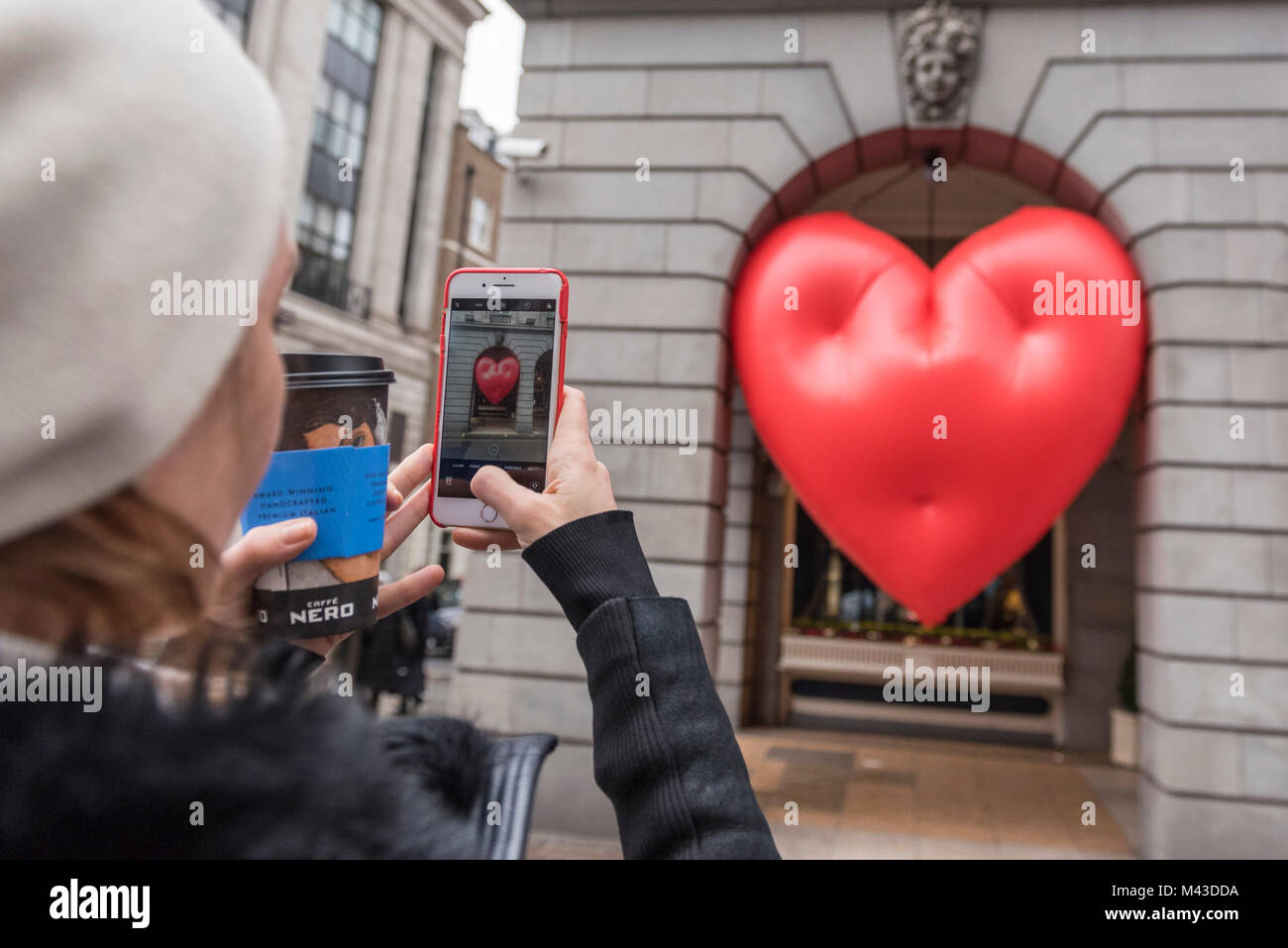 London, UK. 14 February 2018. A tourist takes a photo of a giant chubby ...