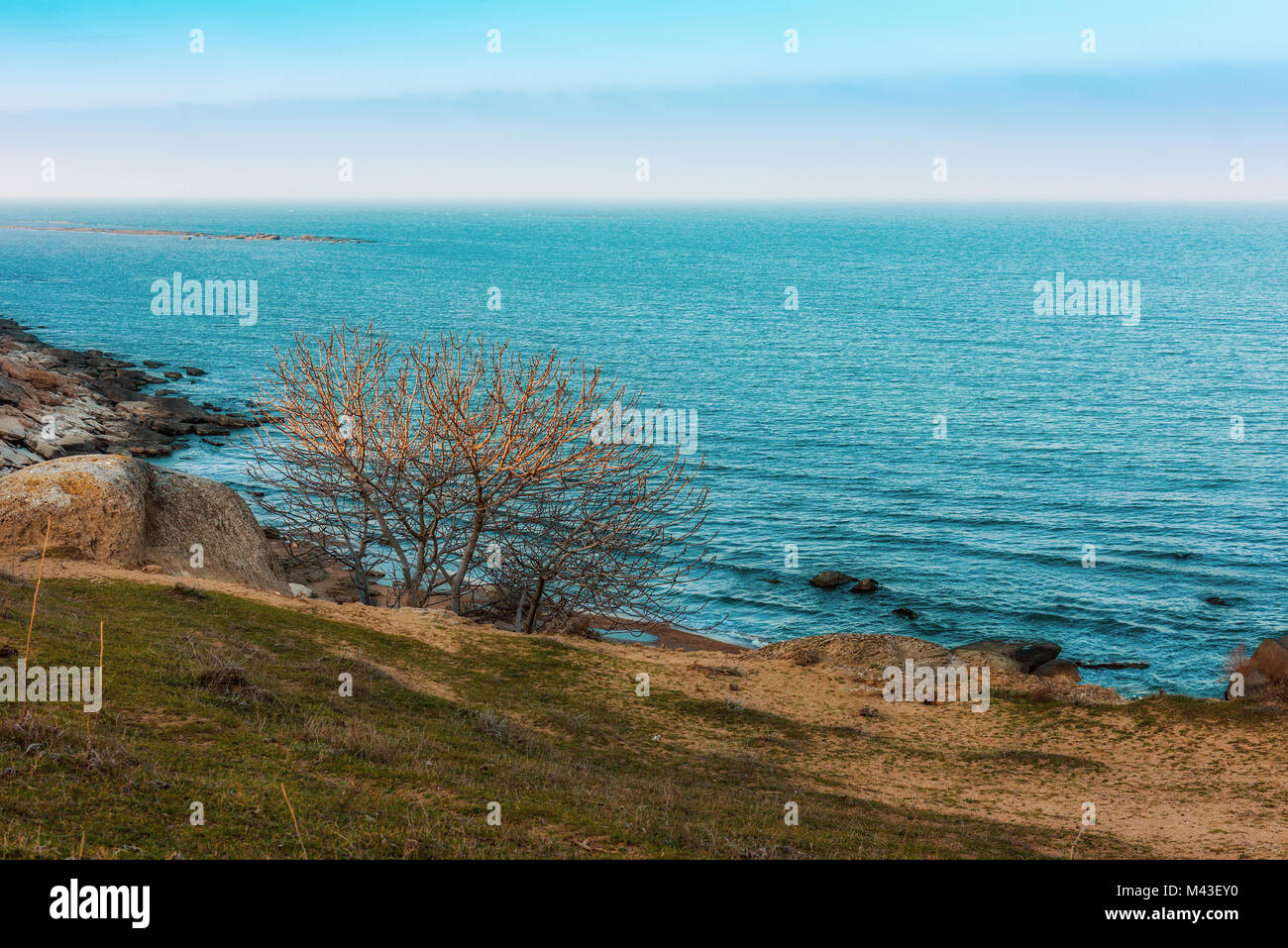 Sea coast with azure water Stock Photo - Alamy