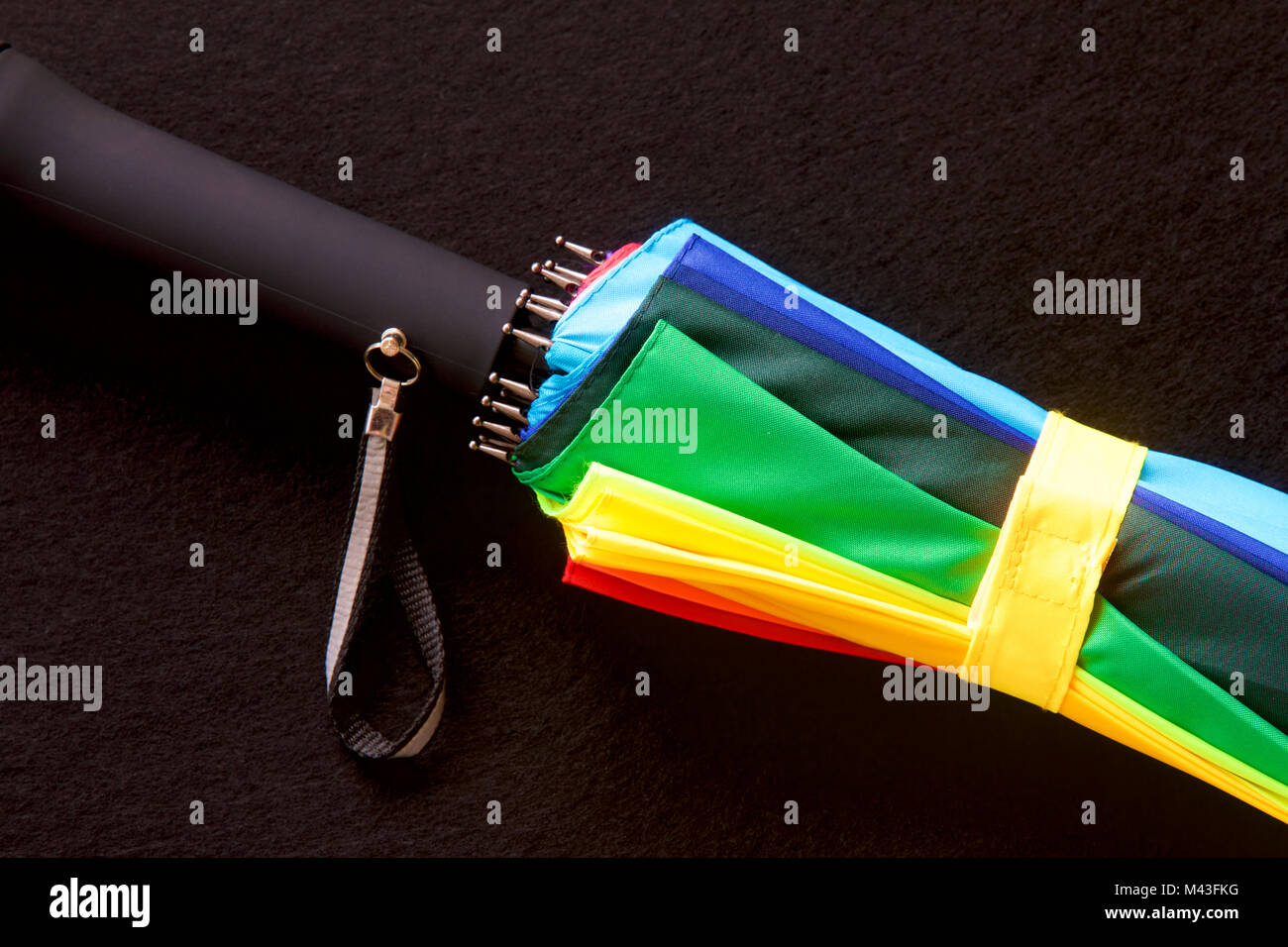 Closed multicoloured umbrella Stock Photo - Alamy