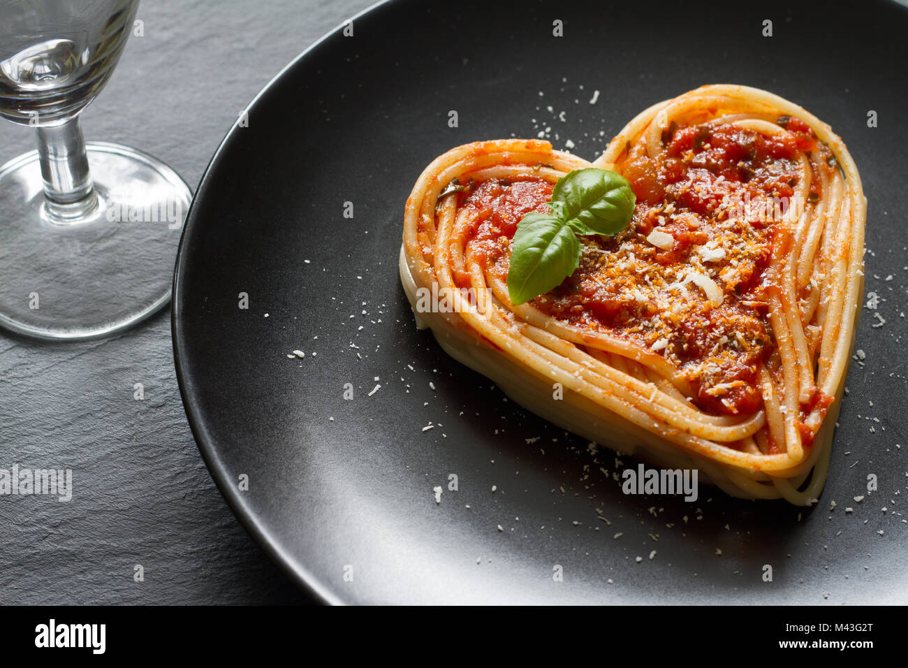 Spaghetti pasta heart love italian food diet abstract concept on black ...