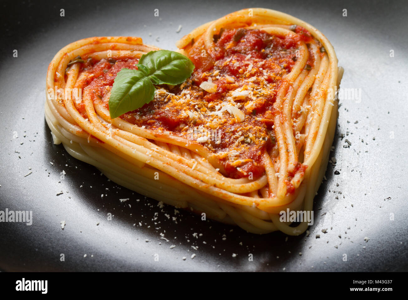 Spaghetti pasta heart love italian food diet abstract concept on black ...