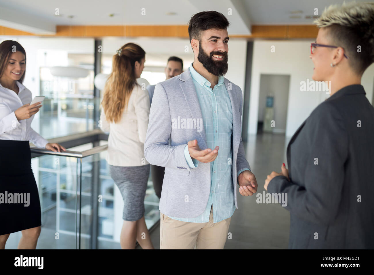 Picture of business colleagues talking in office Stock Photo - Alamy