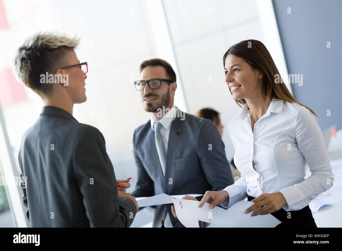 Picture of business colleagues talking in office Stock Photo - Alamy