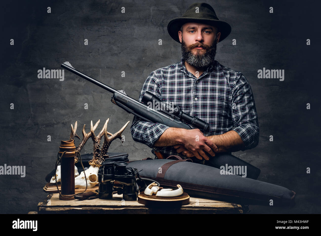Bearded traditional hunter with his trophy holds a rifle Stock Photo ...