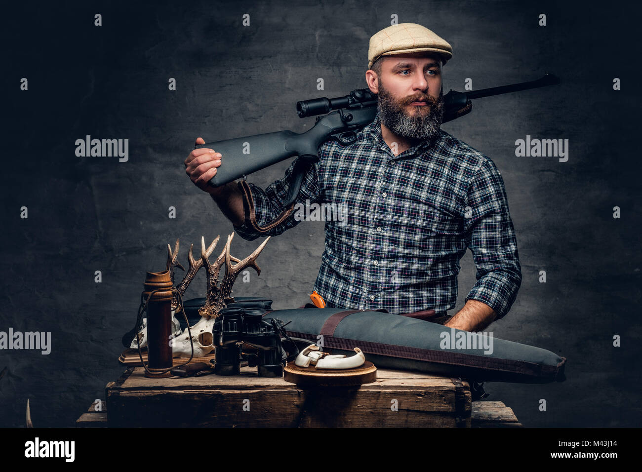 Bearded traditional hunter with his trophy holds a rifle Stock Photo ...