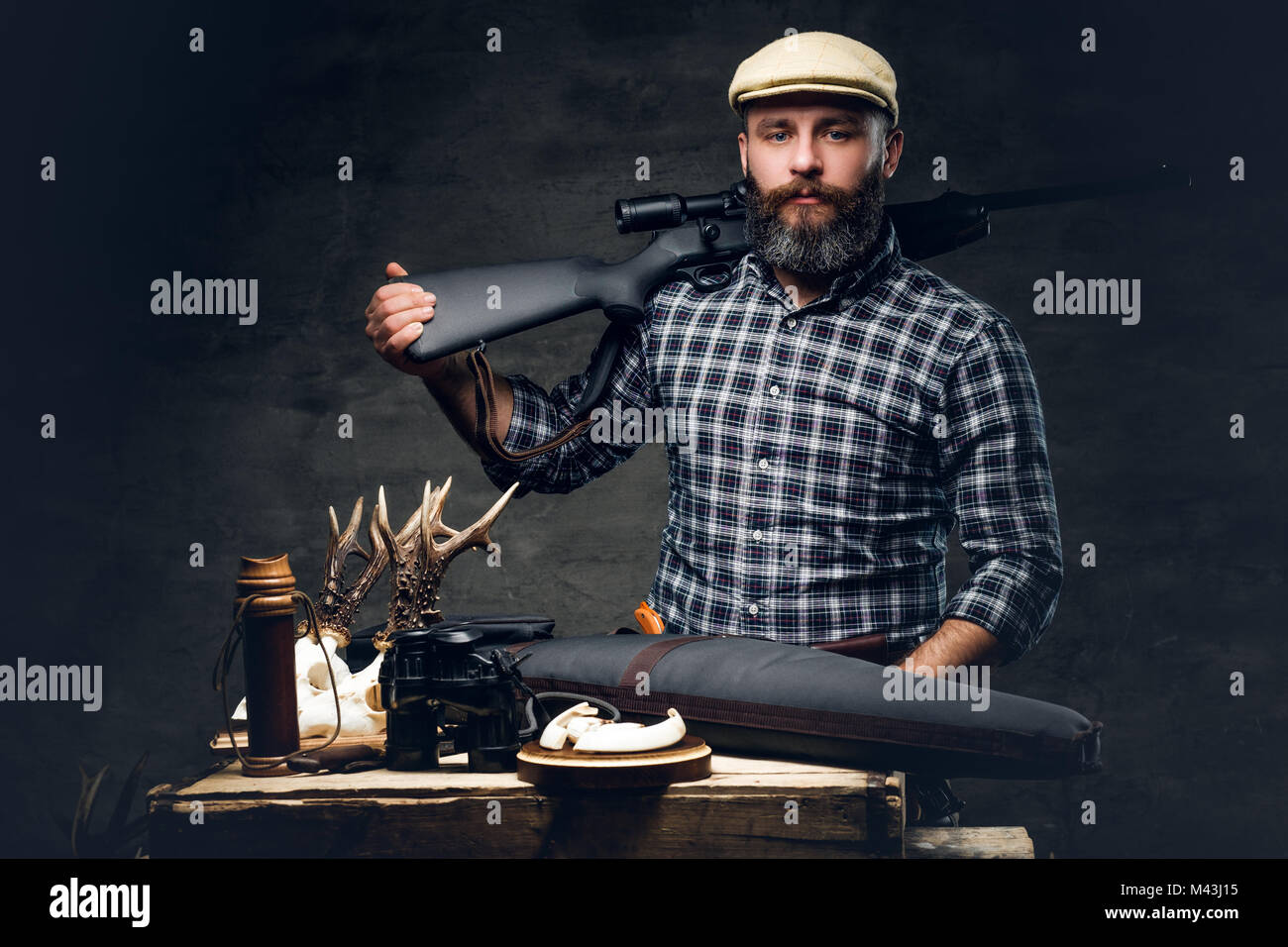 Bearded traditional hunter with his trophy holds a rifle Stock Photo ...