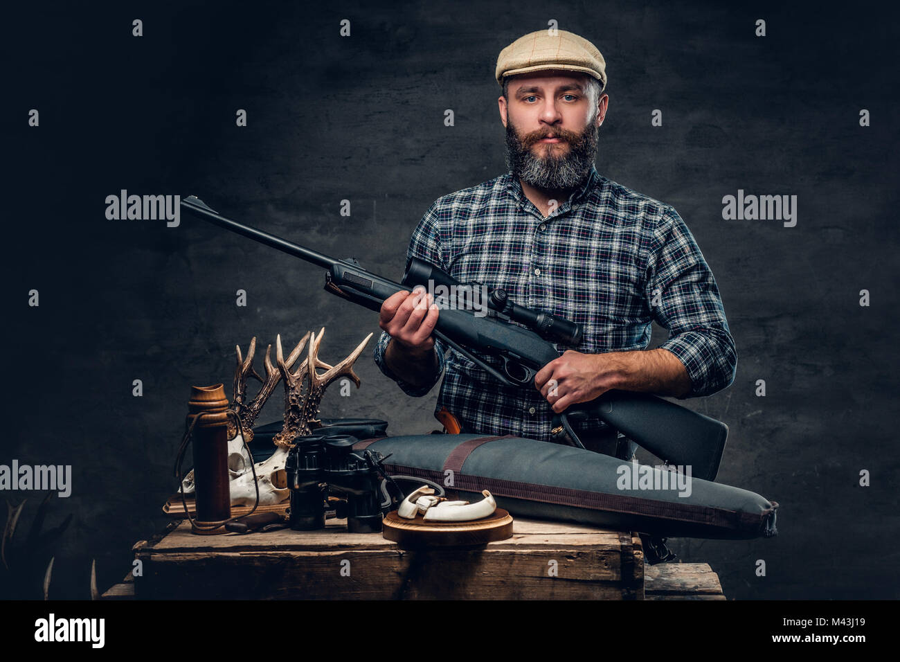 Bearded traditional hunter with his trophy holds a rifle Stock Photo ...