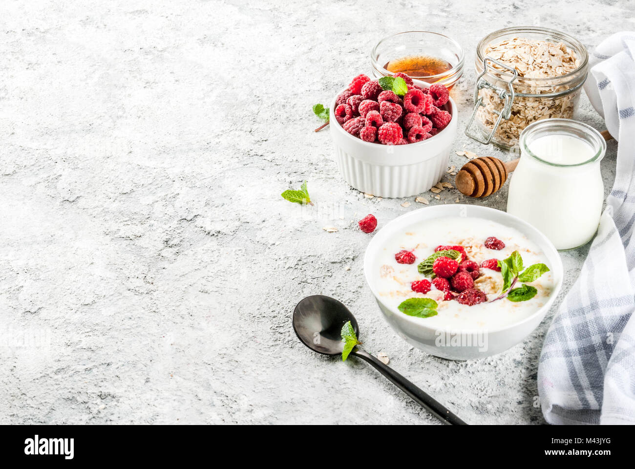 Raw ingredients for summer healthy breakfast, cereals (oats), fresh ...