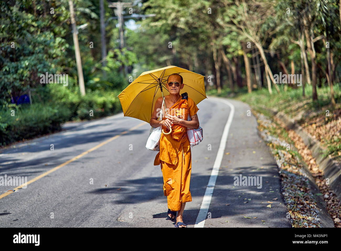 Thai monk with umbrella hi-res stock photography and images - Alamy