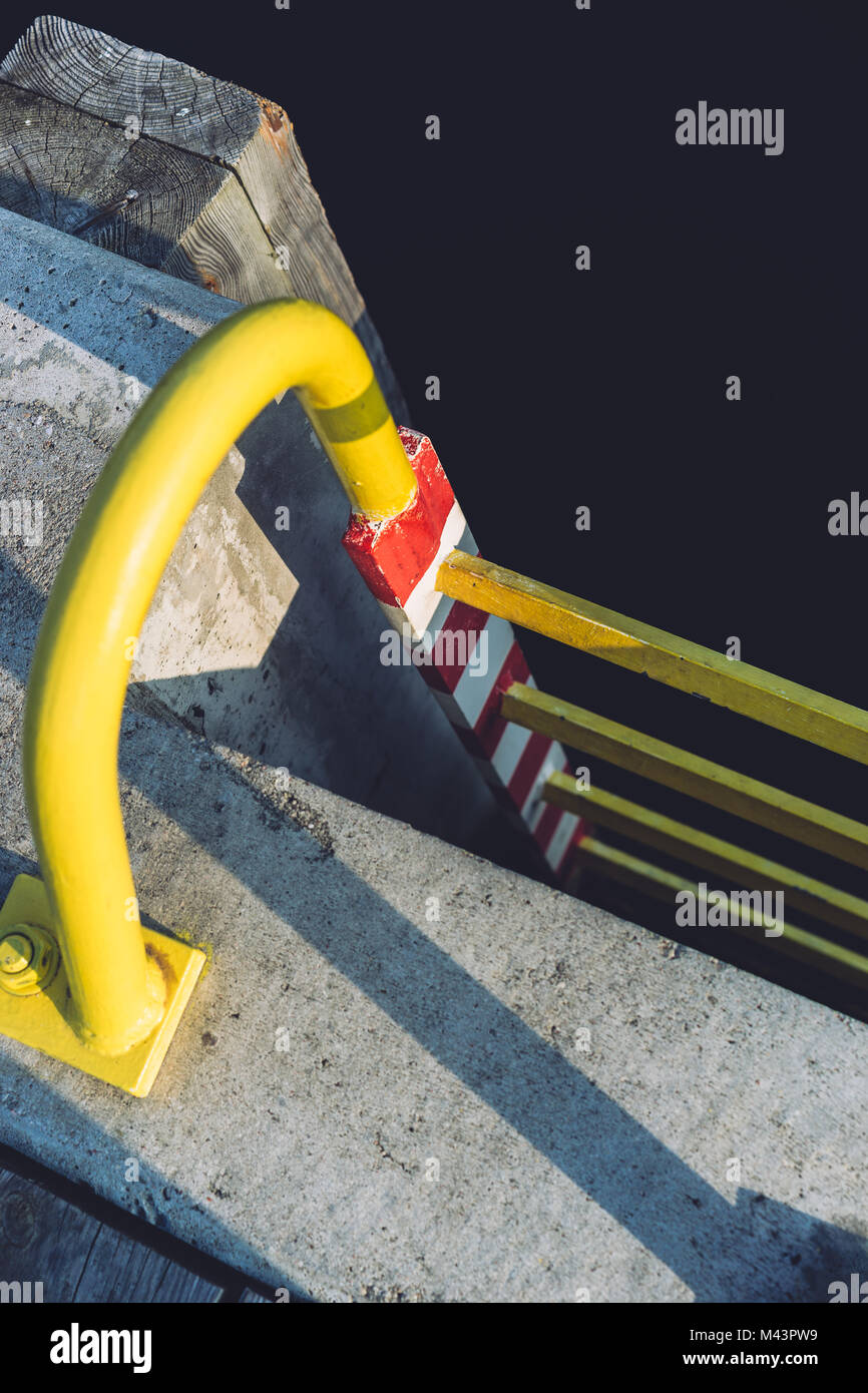 Old yellow ladder on a pier, leading to the sea Stock Photo - Alamy