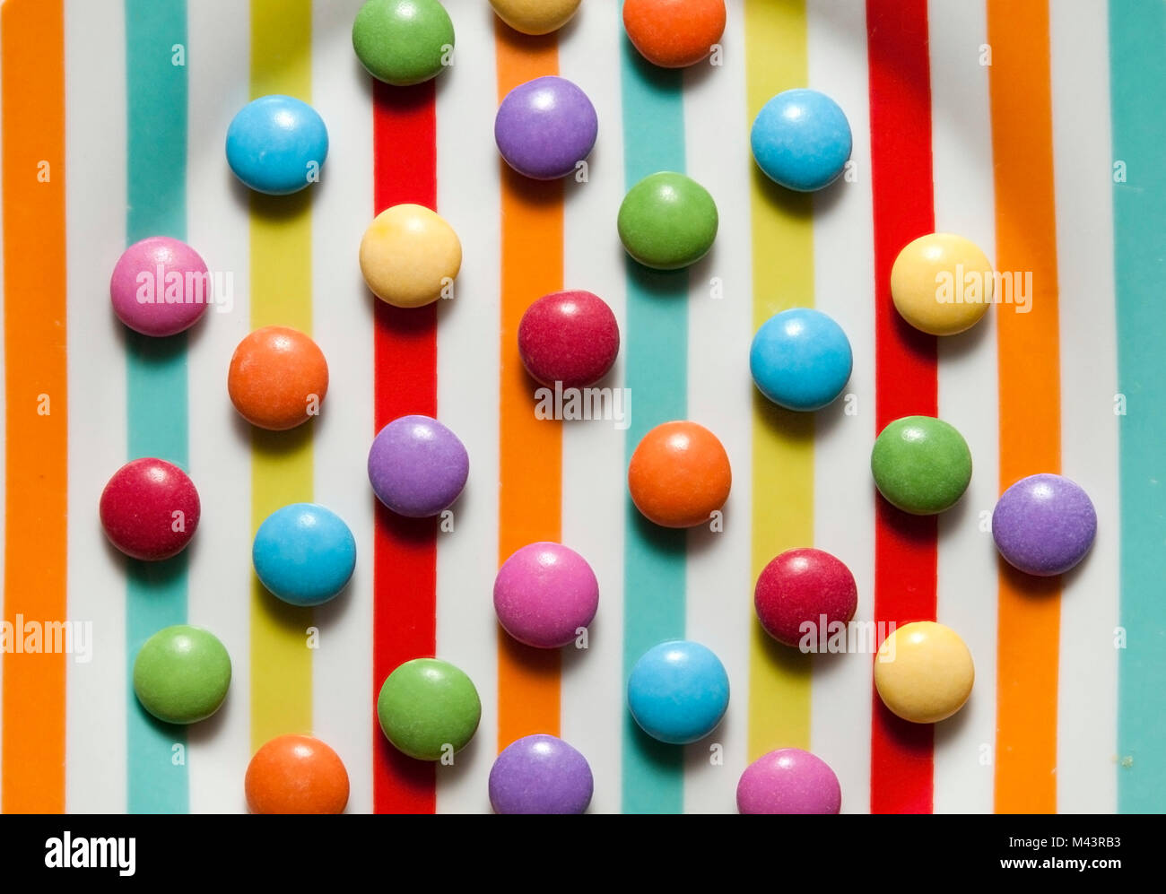 colorful candies on colorful stripes Stock Photo - Alamy