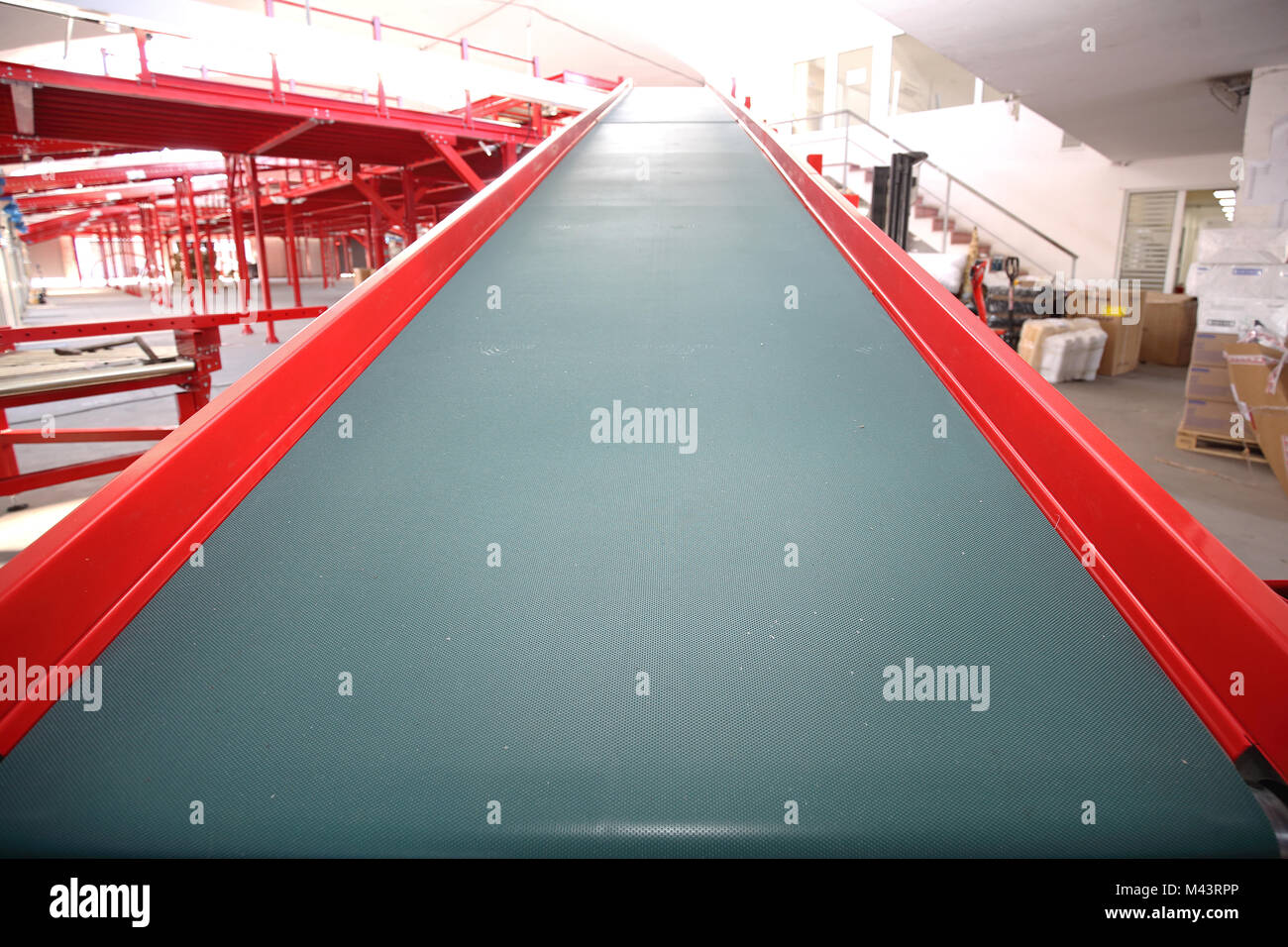 Conveyor Belt Loading Ramp in Sorting Warehouse Stock Photo - Alamy