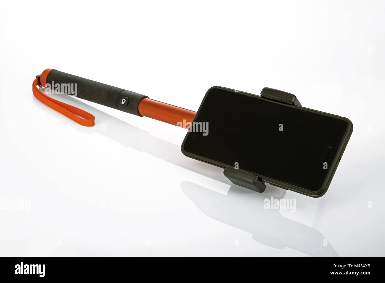 Selfie Stick with cell phone on bright background Stock Photo - Alamy