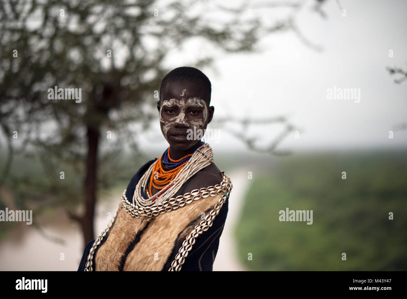 An indigenous Karo man poses in traditional dress with painted face by ...