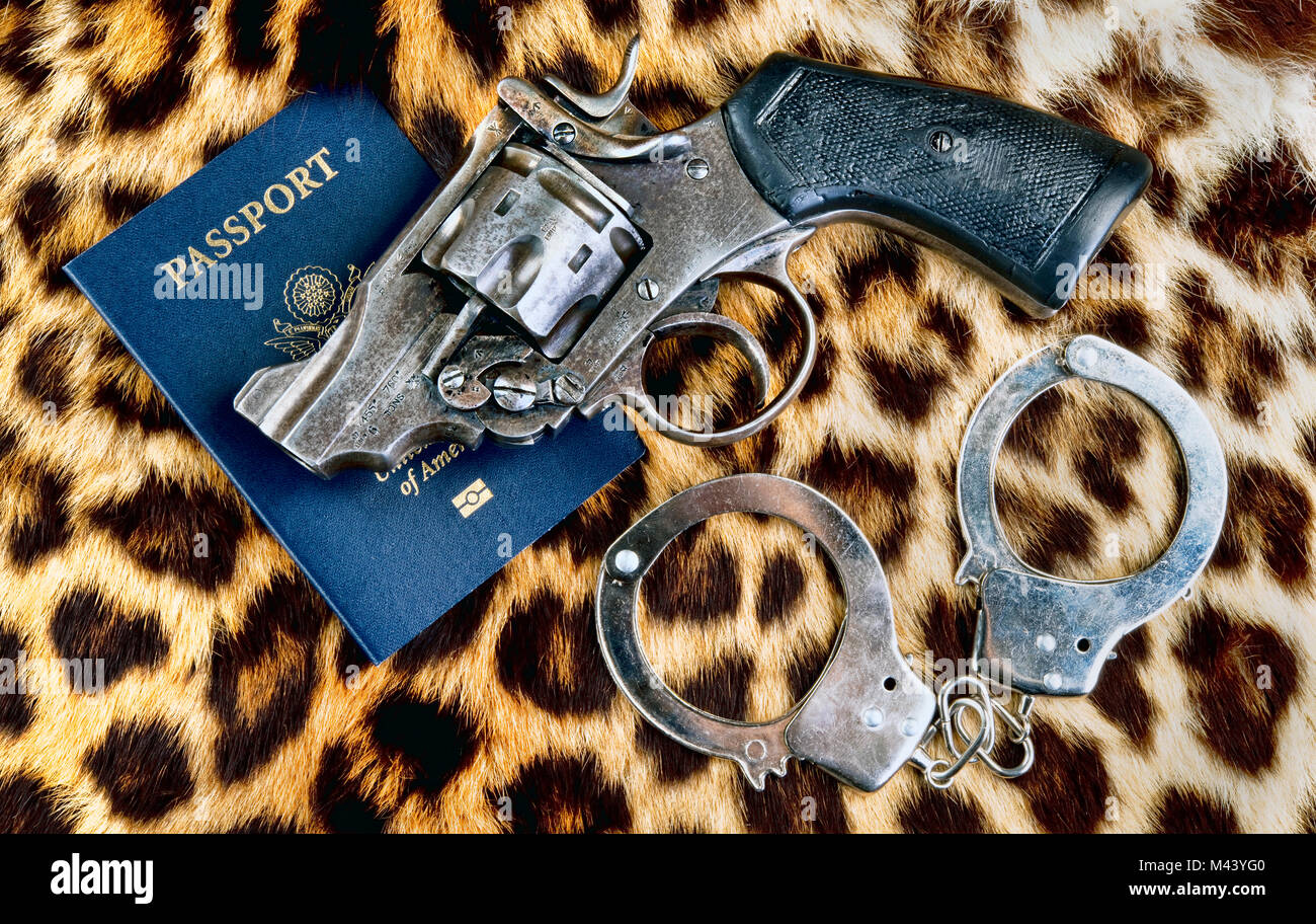 Old pistol,handcuffs and passport on leopard skin Stock Photo - Alamy