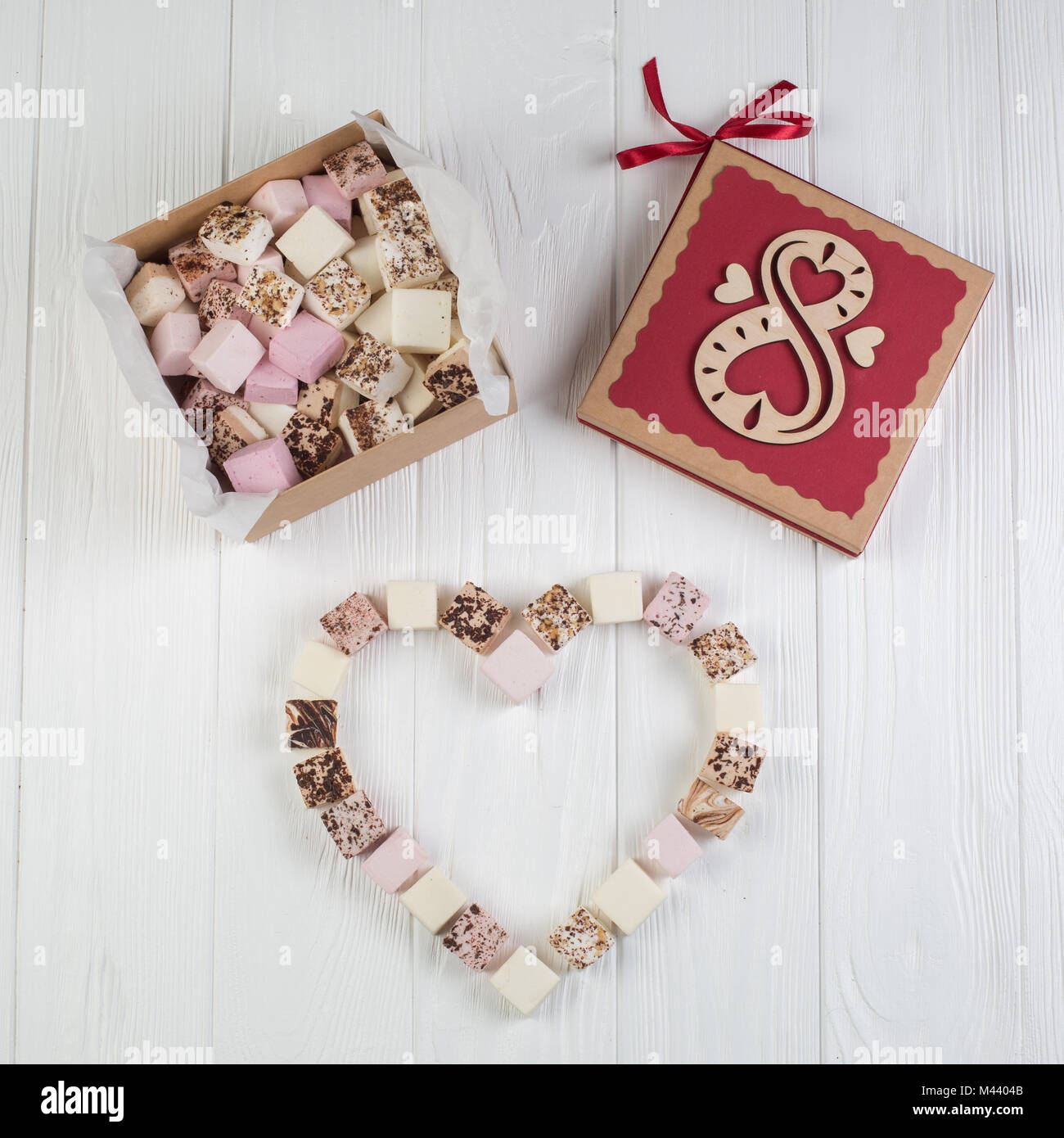 Assorted marshmallow on white wood table with gift box for eight march ...