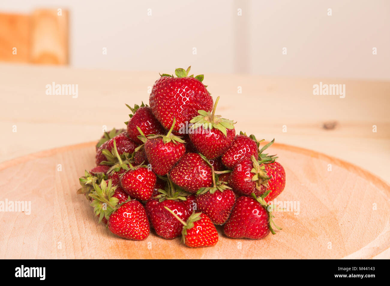 Fresh, juicy strawberries on a wood table Stock Photo - Alamy