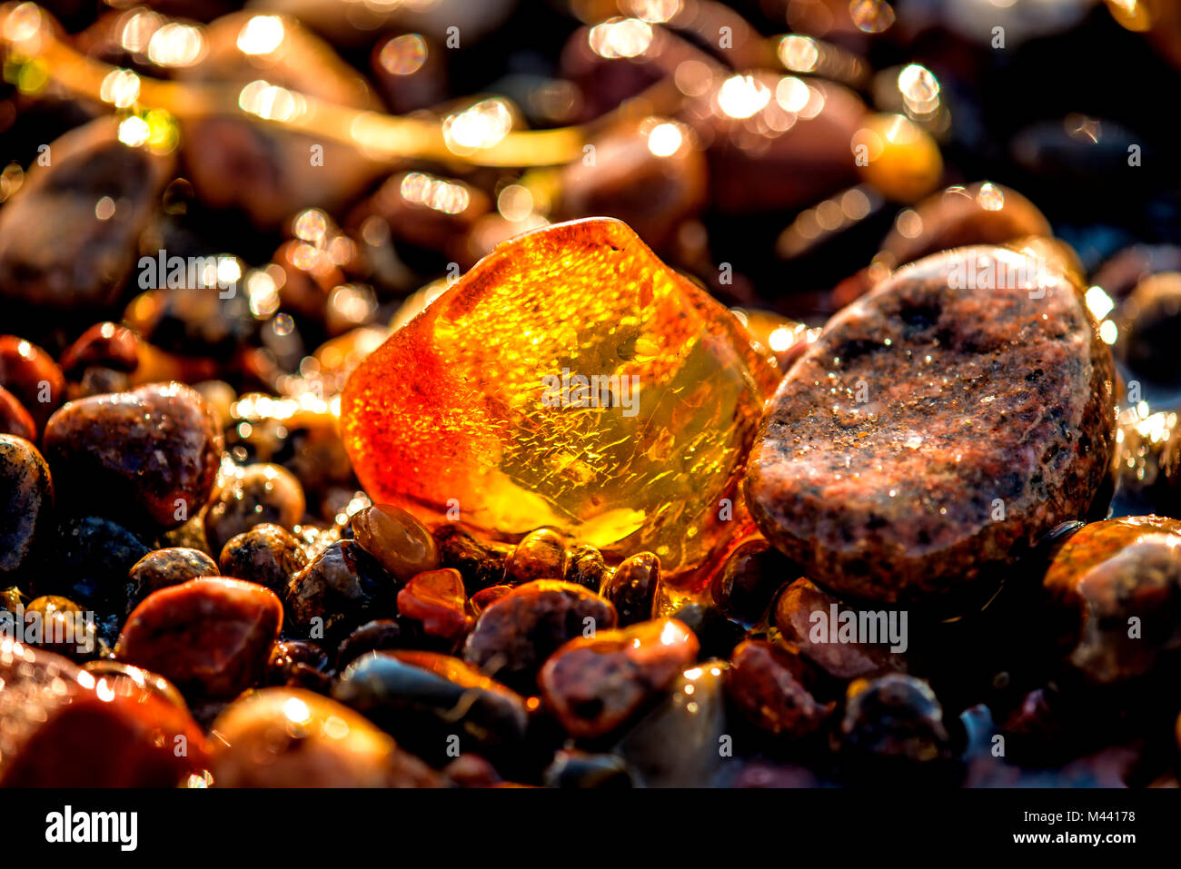 Amber on a beach of the Baltic Sea in the surf Stock Photo - Alamy