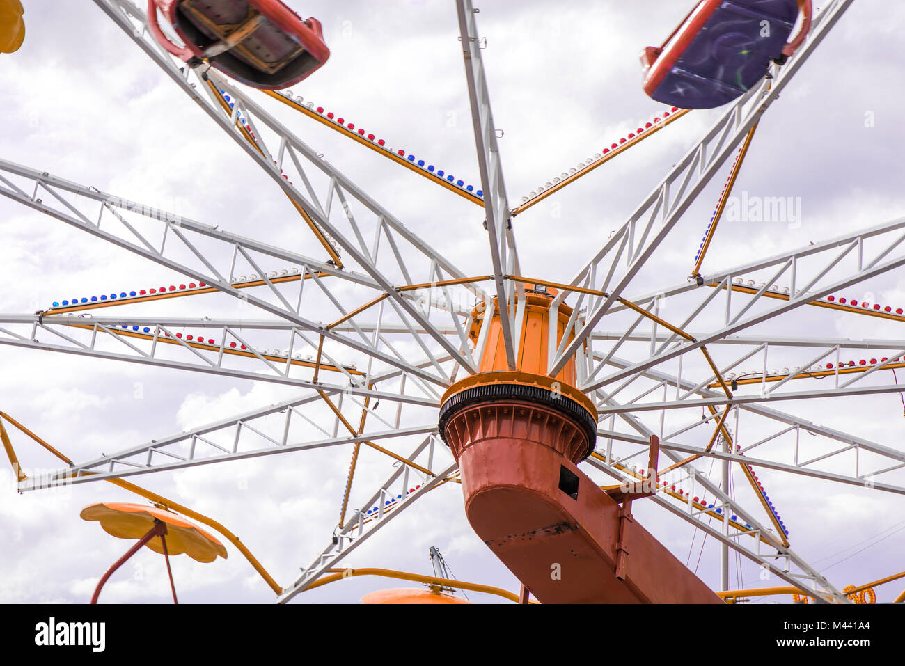 Colorful roller coaster seats at amusement park. People having fun in ...