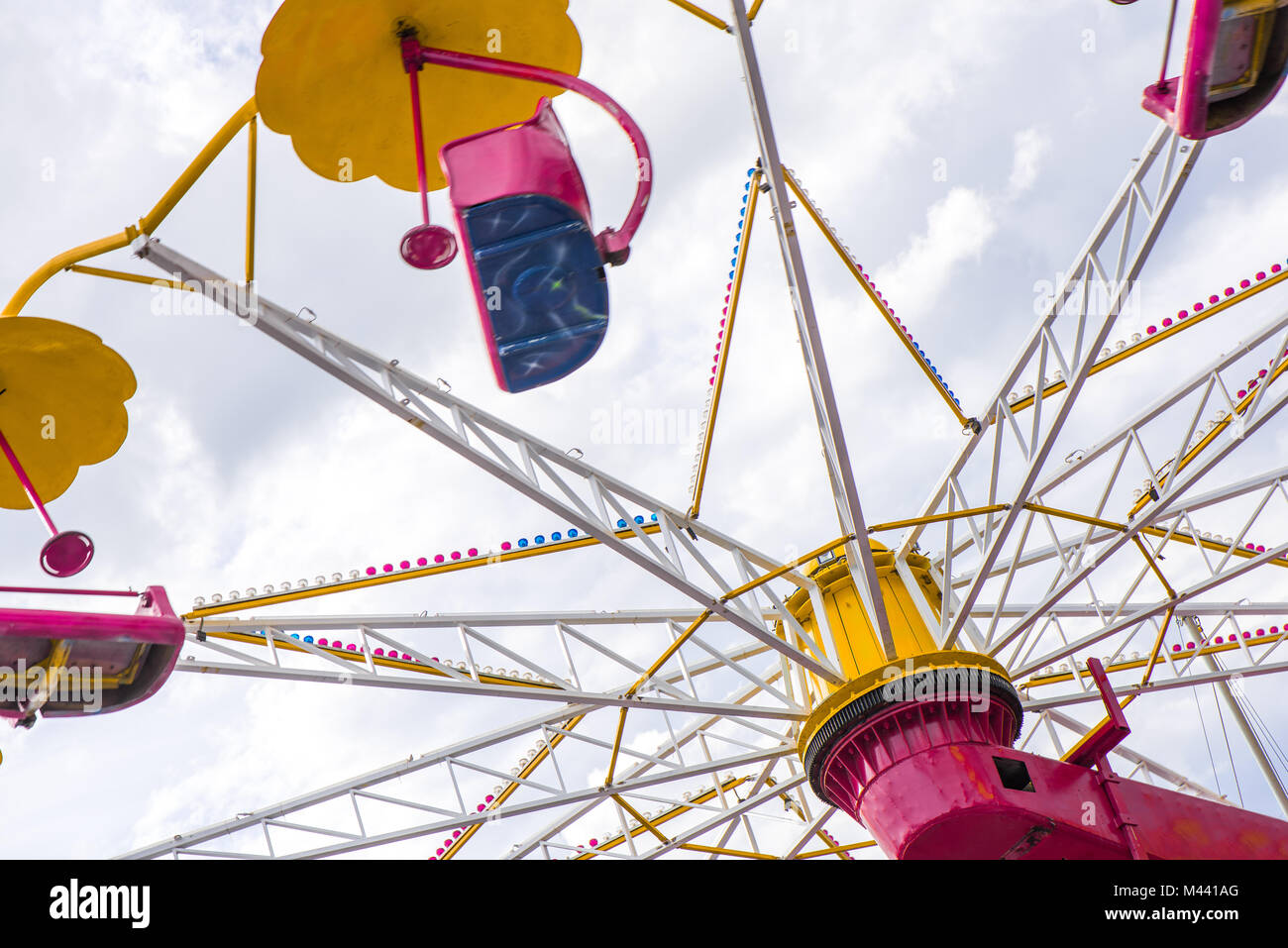 Colorful roller coaster seats at amusement park. People having fun in ...
