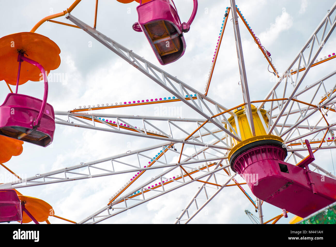 Colorful roller coaster seats at amusement park. People having fun in ...