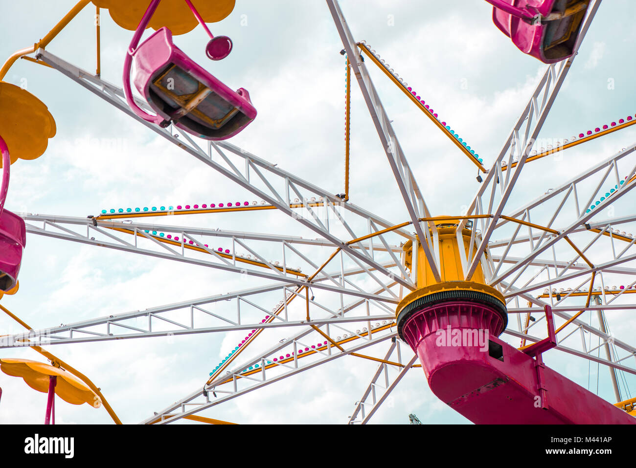 Colorful roller coaster seats at amusement park. People having fun in ...