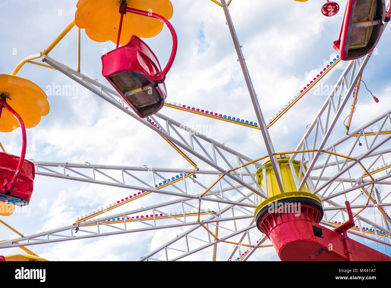 Colorful roller coaster seats at amusement park. People having fun in ...
