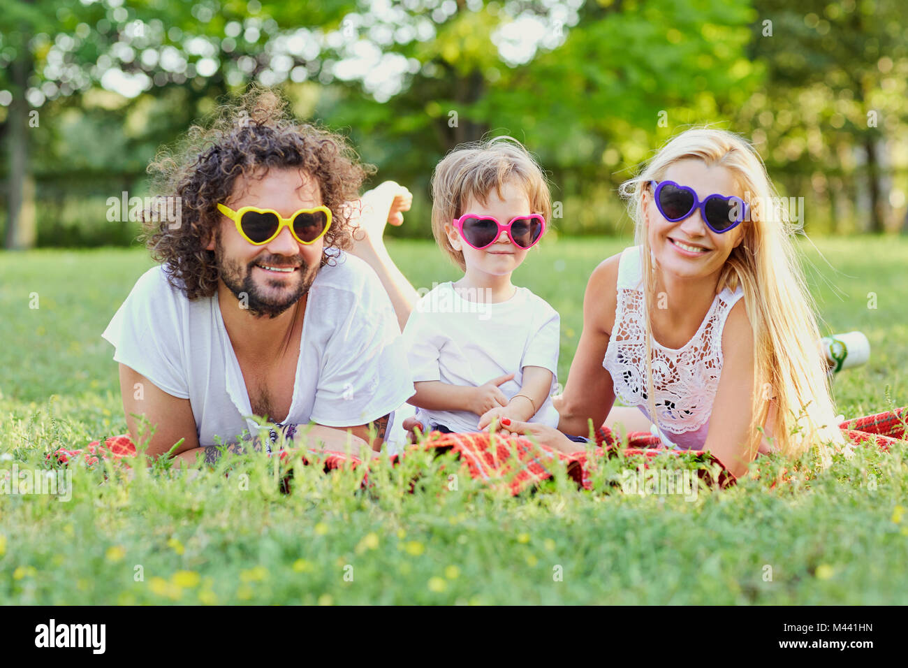 Happy family playing in the park Stock Photo - Alamy