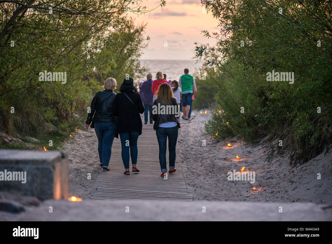 Romantic bonfire night at seaside during sunset. People gathering ...