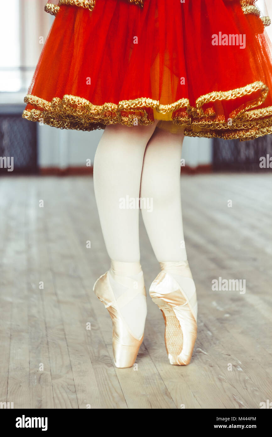 Young ballerina dancing, closeup on legs and shoes, standing in pointe ...