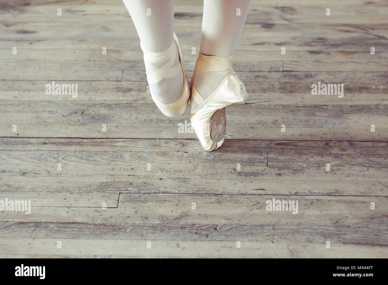 Young ballerina dancing, closeup on legs and shoes, standing in pointe ...