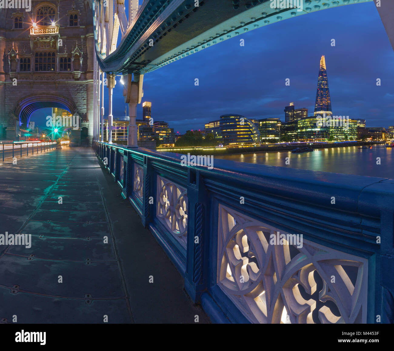 London - The metal construction of Tower Bride and skyscraper at dusk ...