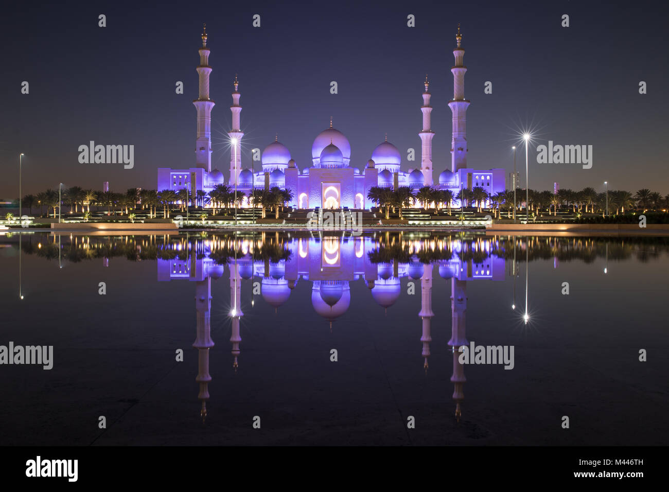 Sheikh Zayed Grand Mosque and it's perfect reflection in a water pool ...