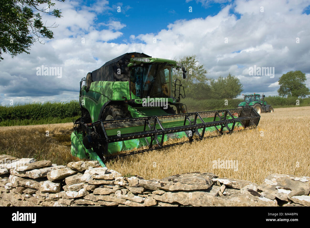 Combine harvester harvesting rural field Stock Photo - Alamy